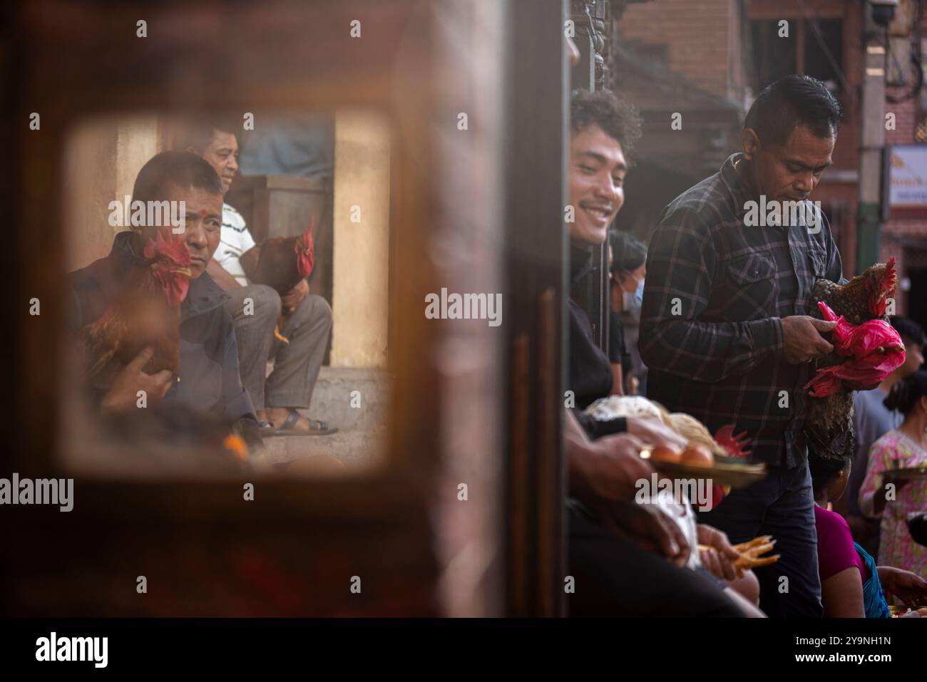 Devotees wait with sacrificial chickens as they prepare to enter ...