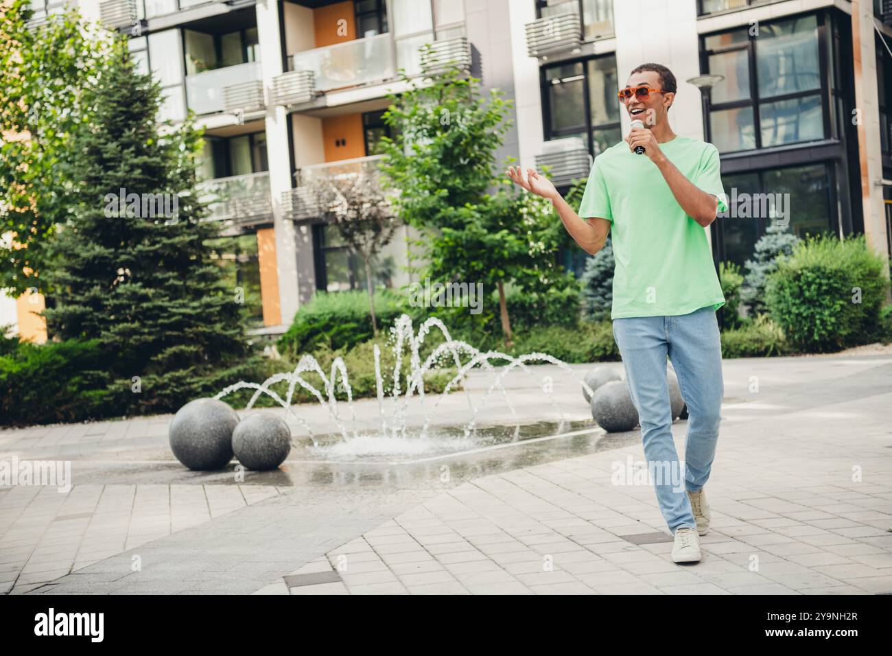 Full size photo of nice young man journalist wear t-shirt speak ...