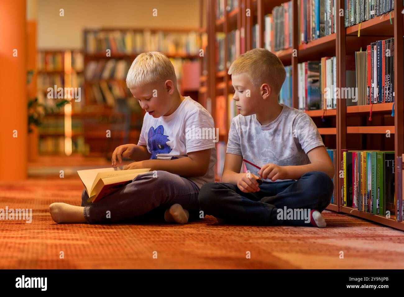 Children in school library. Kids read books. Little boy reading and ...