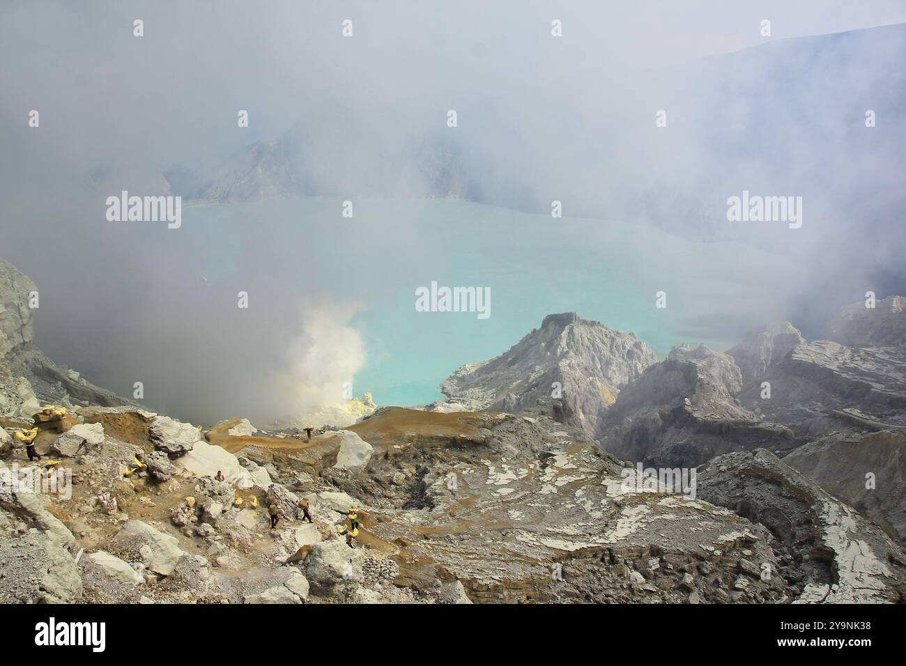The caldera walls of Ijen crater with its turquoise lake indicate the ...
