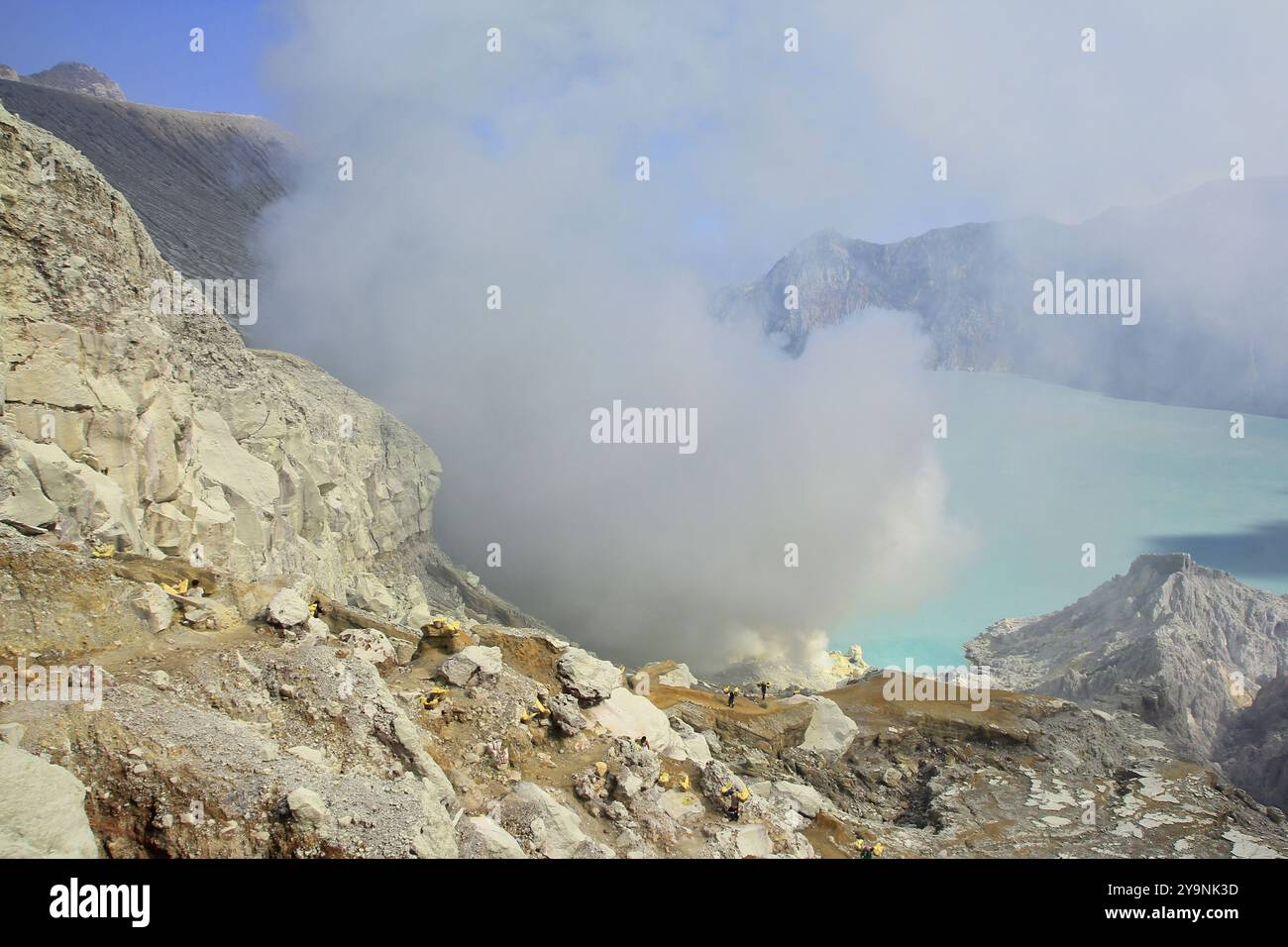 The caldera walls of Ijen crater with its turquoise lake indicate the ...
