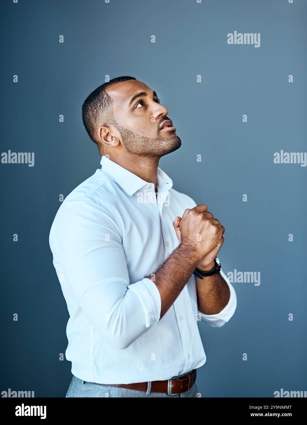 Black man praying working hi-res stock photography and images - Alamy