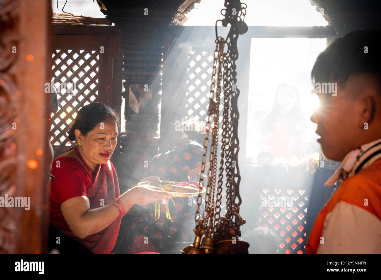 Devotees wait to perform rituals inside the Balkumari Temple during ...