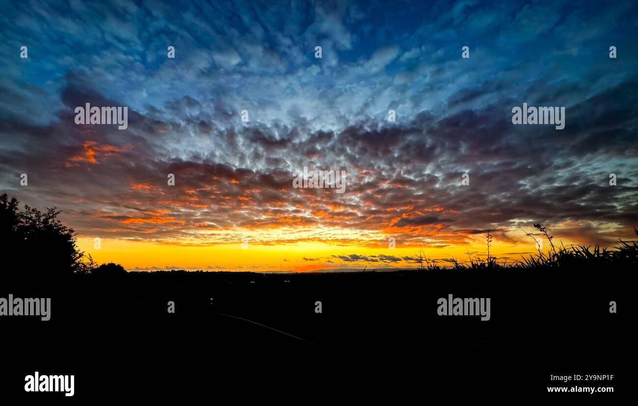 A view of high-ground hills in Auckland lays of sunlights on the ...