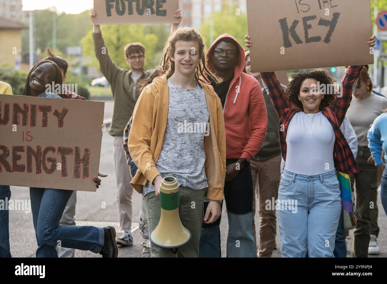 Group of diverse young people at a peaceful demonstration, holding ...