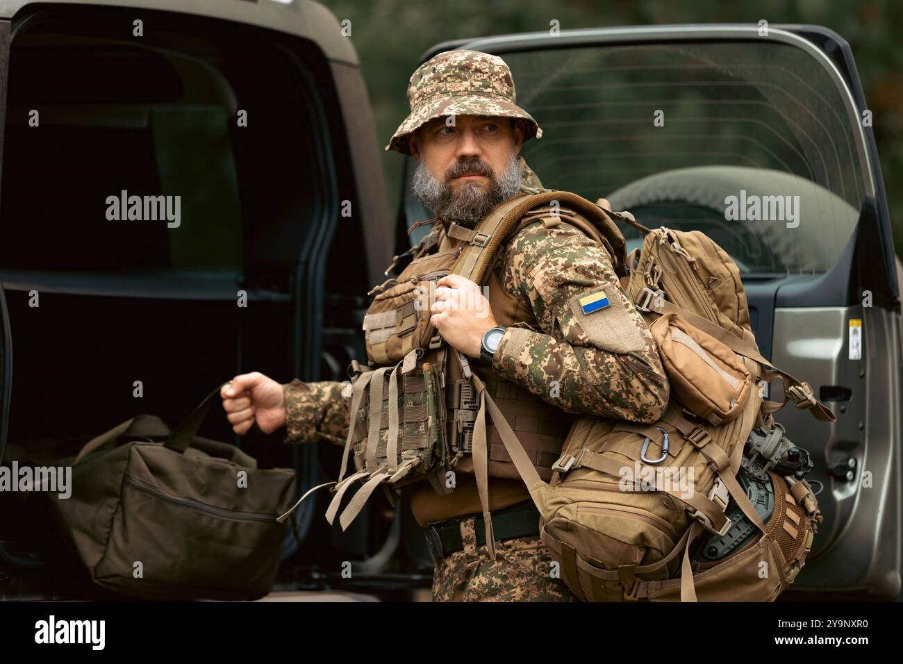 Portrait of a military man dressed in ammunition. The military man ...