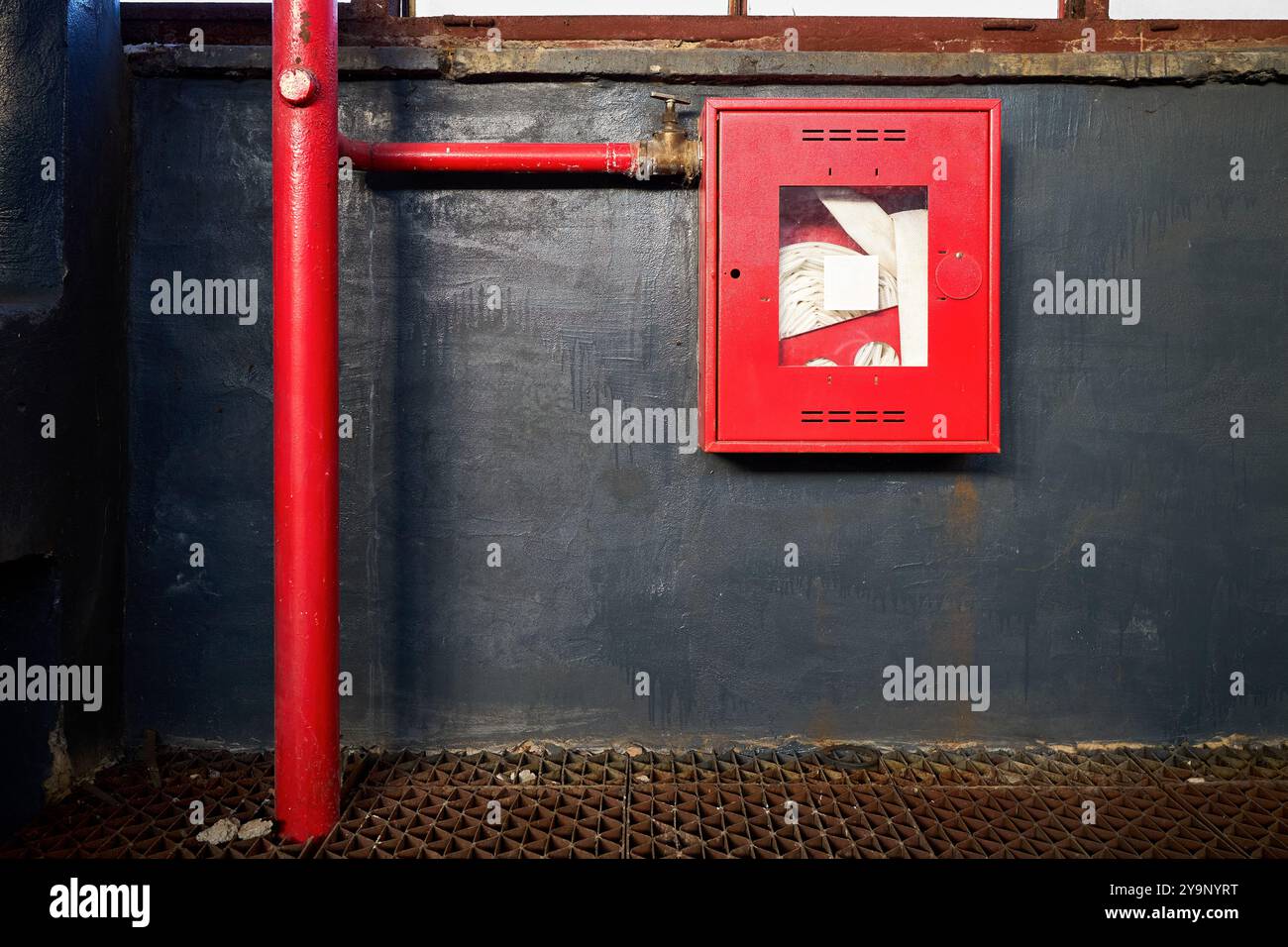 Fire hose in red box. Pipe roll for fire emergency in red metal cabinet ...