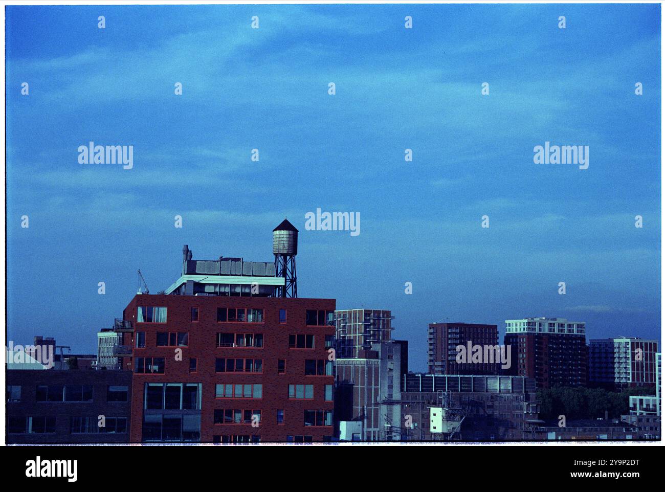 Rotterdam city skyline roof tops and water tower seen from the harbour ...