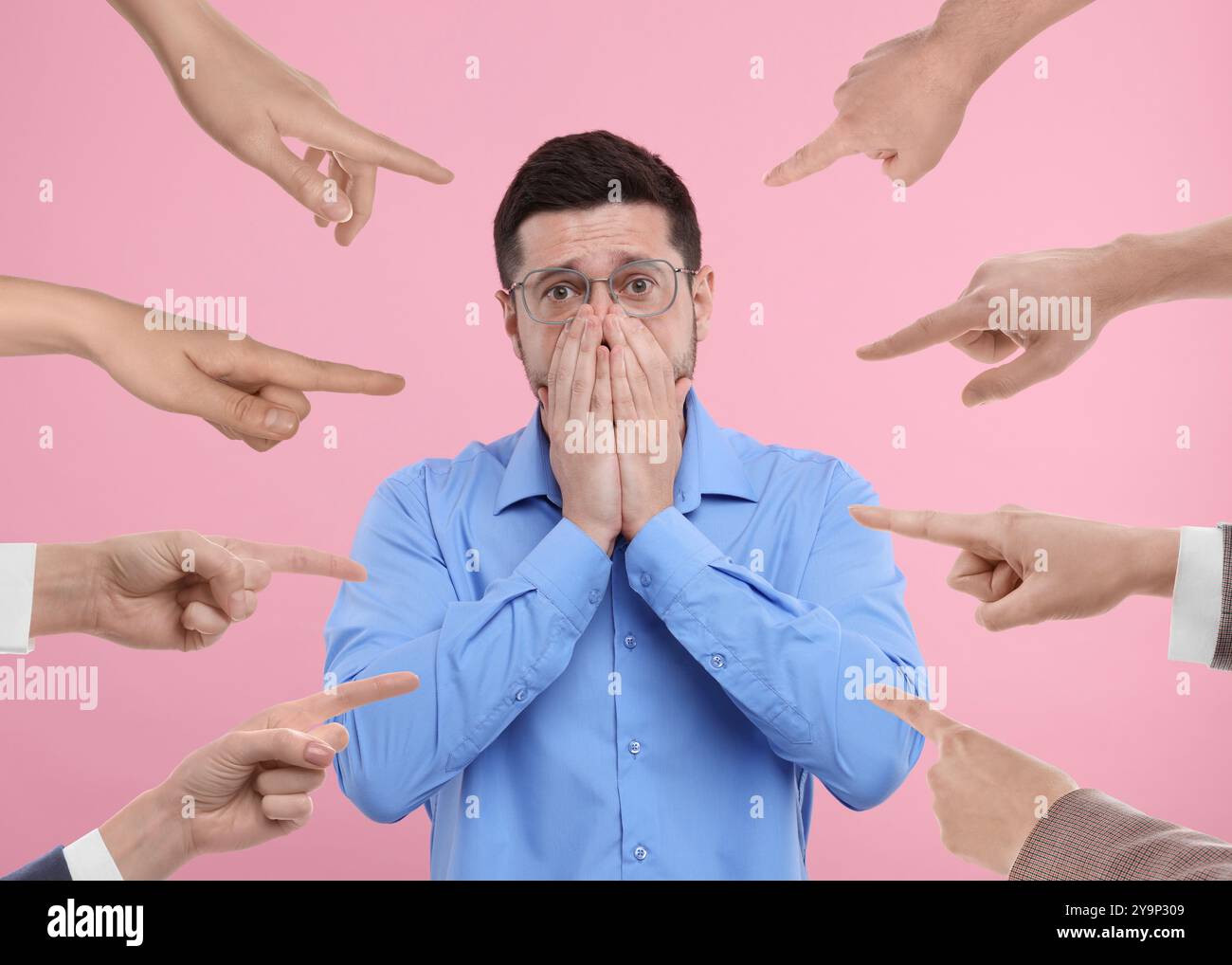 People pointing at embarrassed man on pink background Stock Photo - Alamy