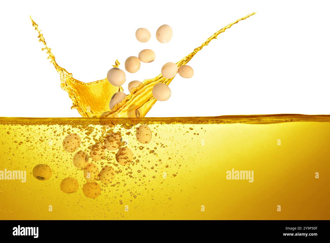 Soy beans falling into vegetable oil on white background Stock Photo ...