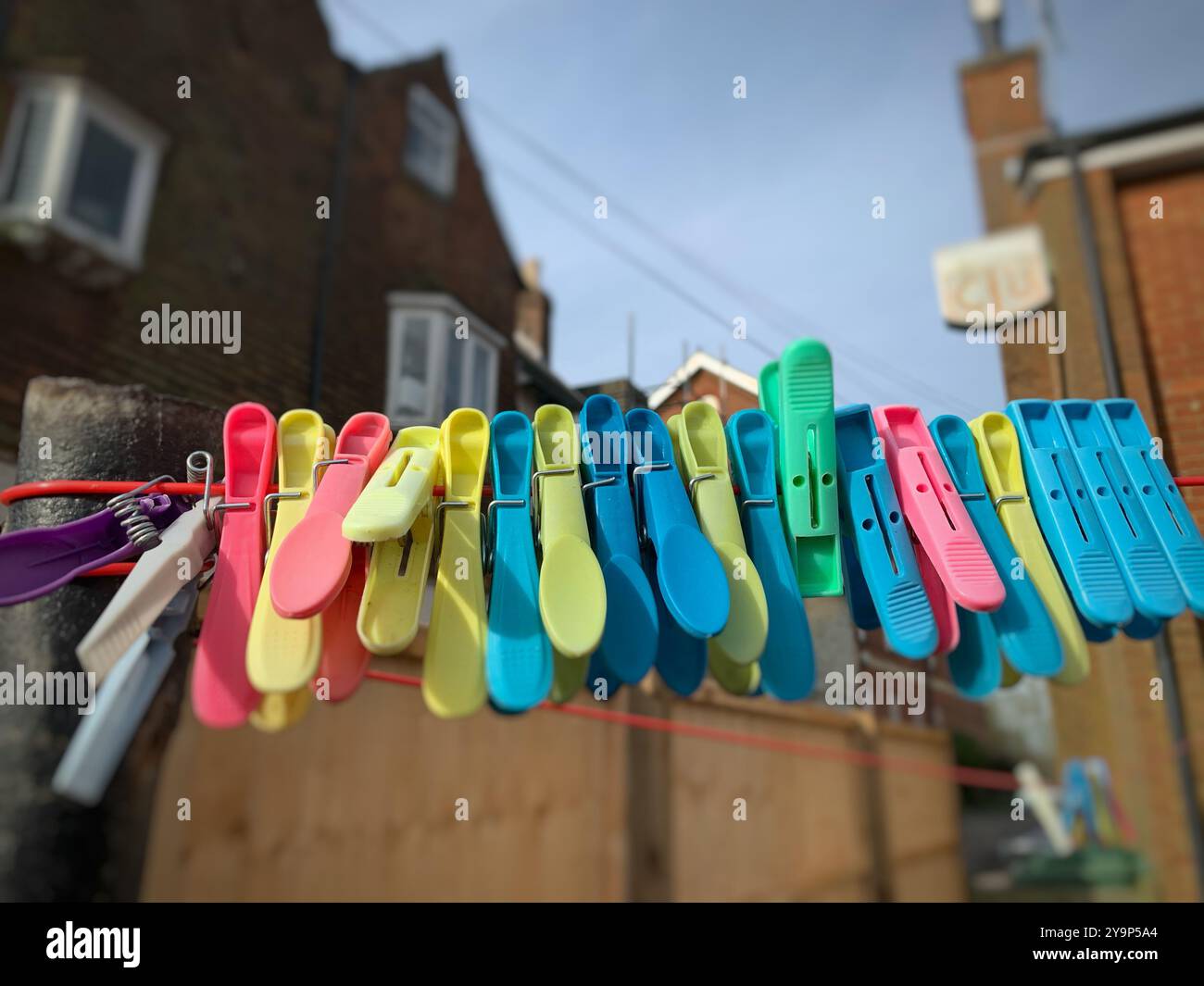 coloured clothes pegs on washing line, London Stock Photo - Alamy