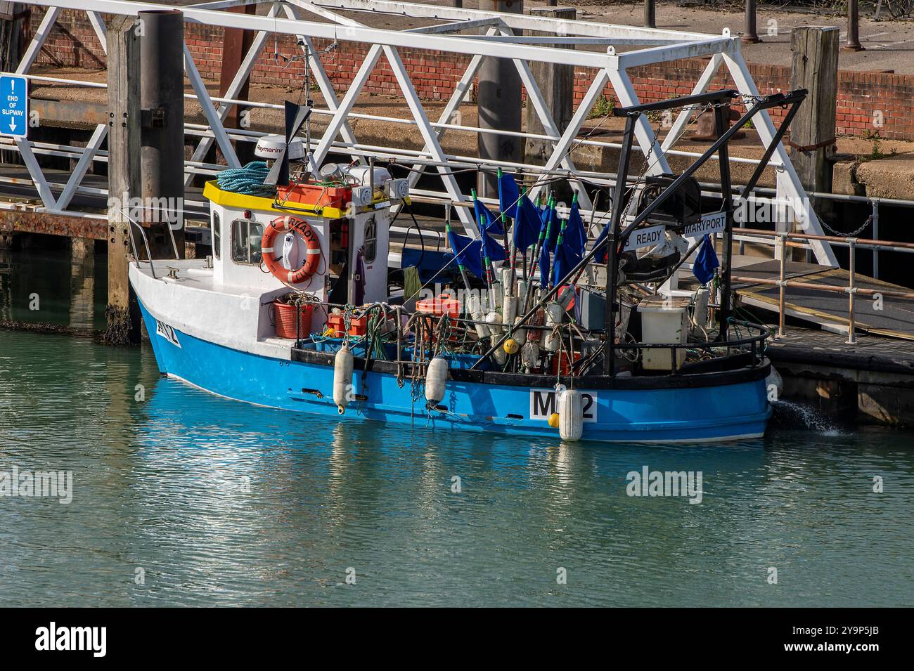 inshore fishing boat or trawler alongside a pier or jetty in Camber ...