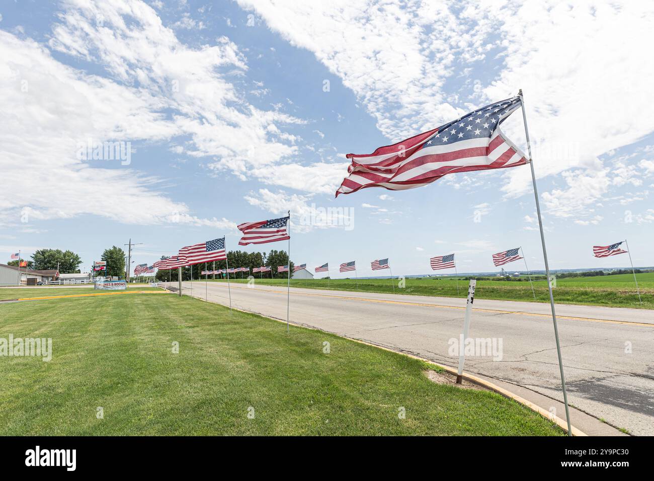 Road lined with American flags on a grassy area Stock Photo - Alamy