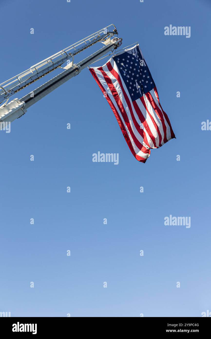 American flag hanging from a fire truck ladder in the sky Stock Photo ...