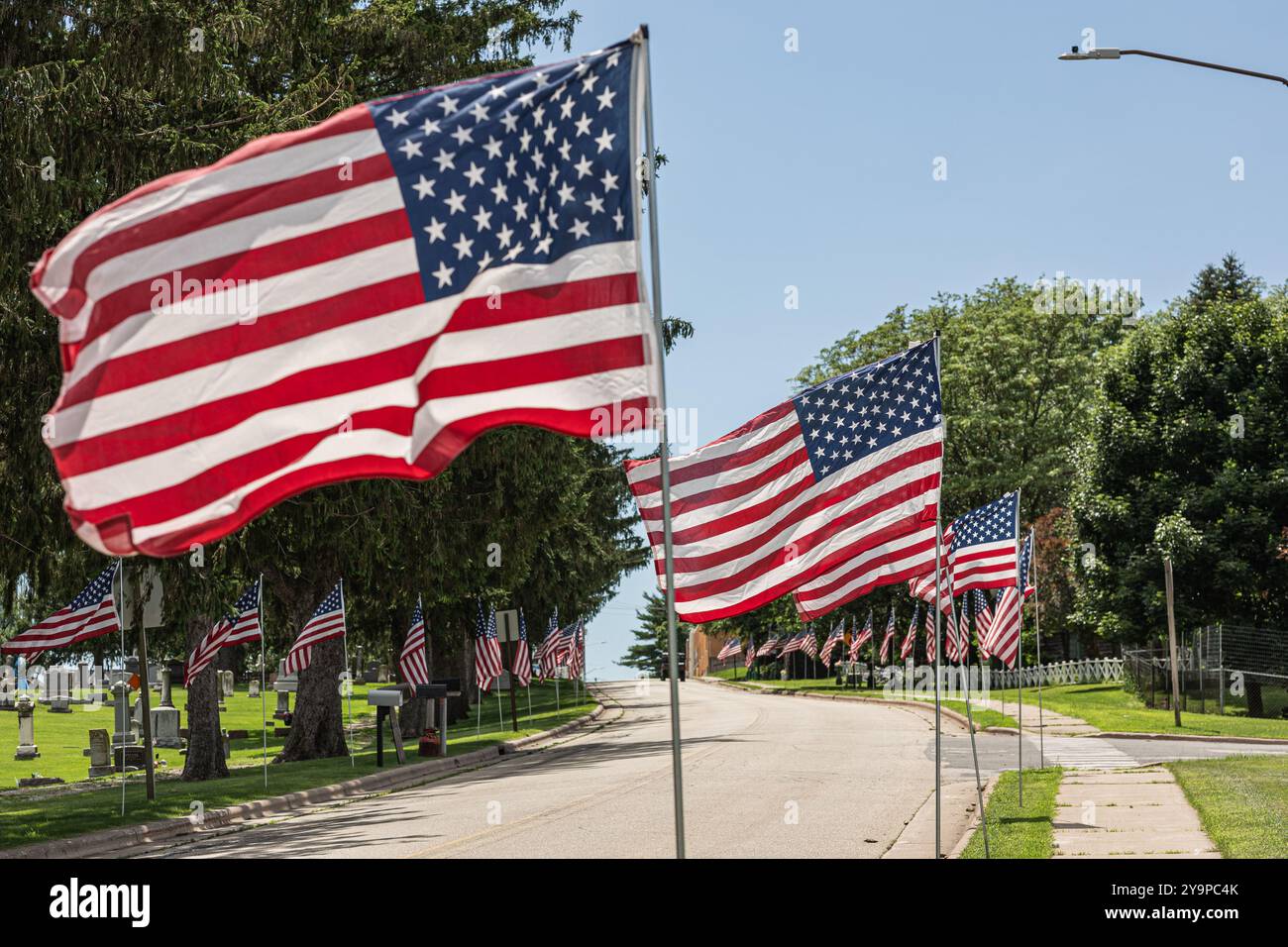 Road lined with American flags on a grassy area Stock Photo - Alamy