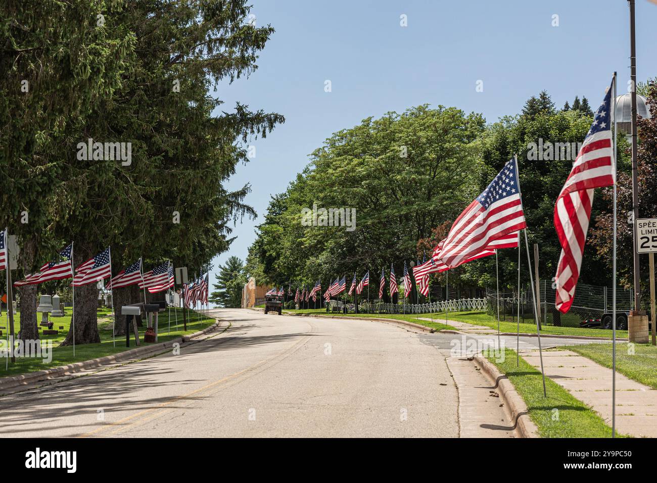 Road lined with American flags on a grassy area Stock Photo - Alamy