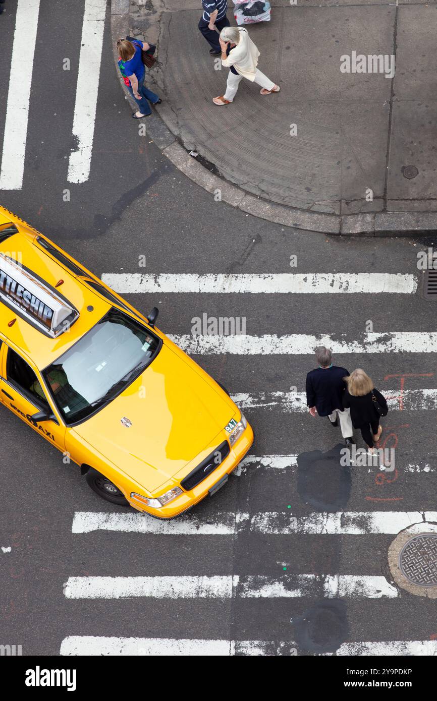 Top down view of yellow cab and pedestrians at NYC intersection Stock ...