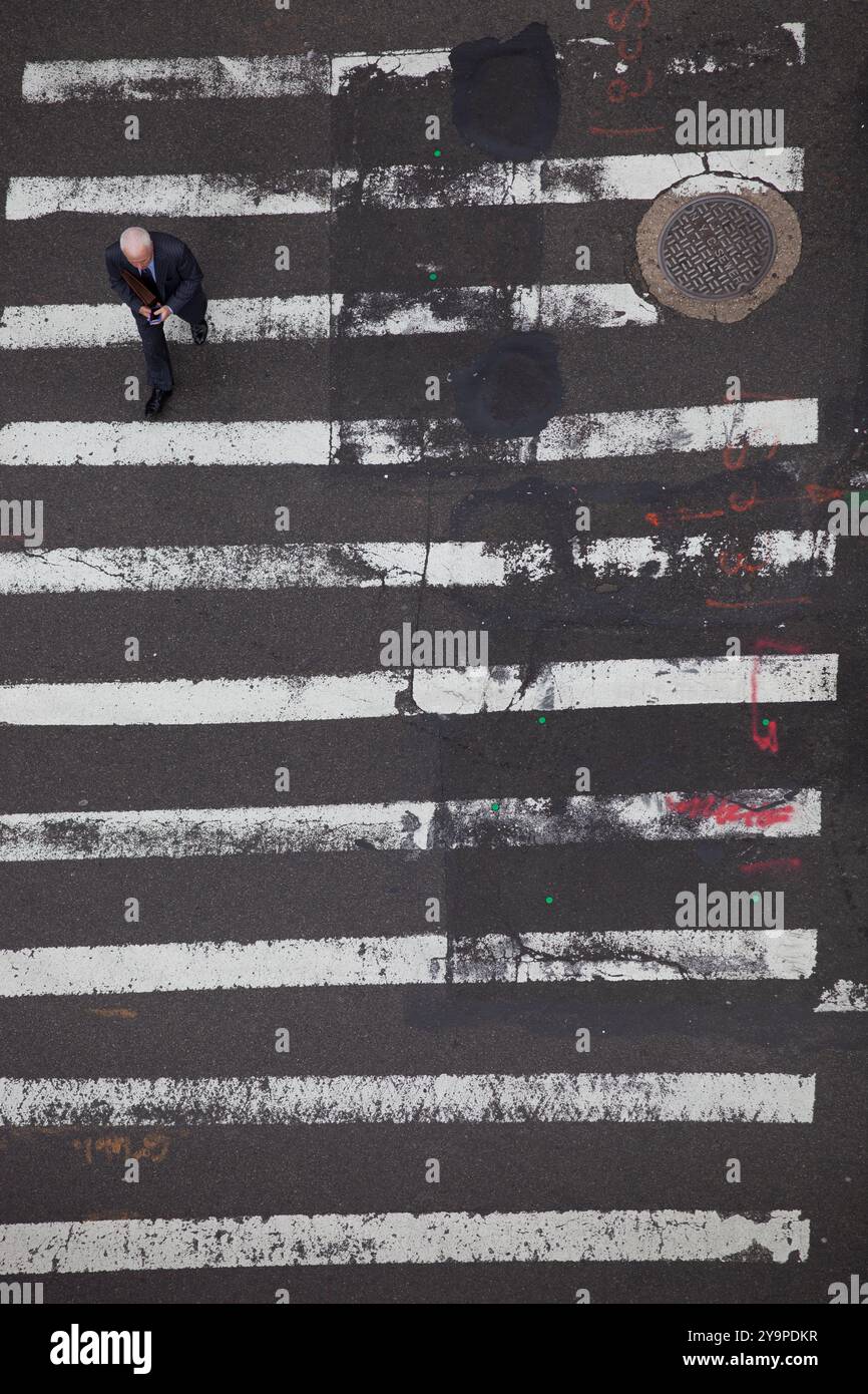 Business man crossing crosswalk from above looking down Stock Photo - Alamy