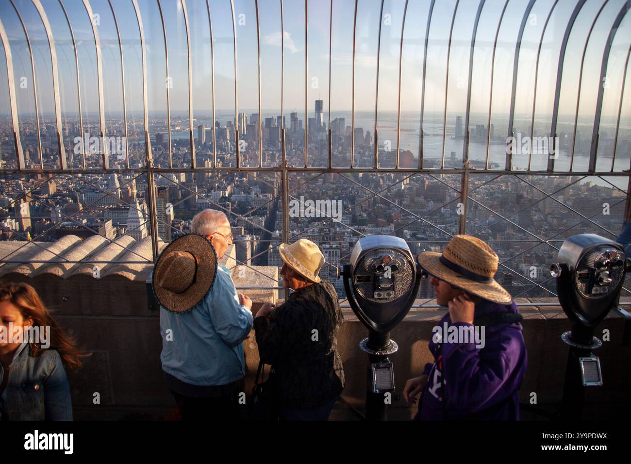 People looking out from top on Empire State Building NYC Stock Photo ...