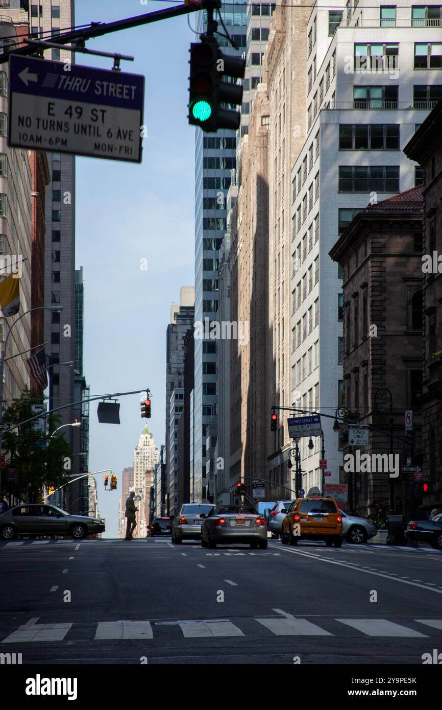 View looking up New York City street between tall buildings vertical ...