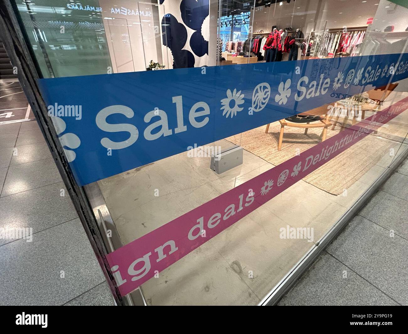 Colorful Sale signs in clothes shop window Stock Photo - Alamy