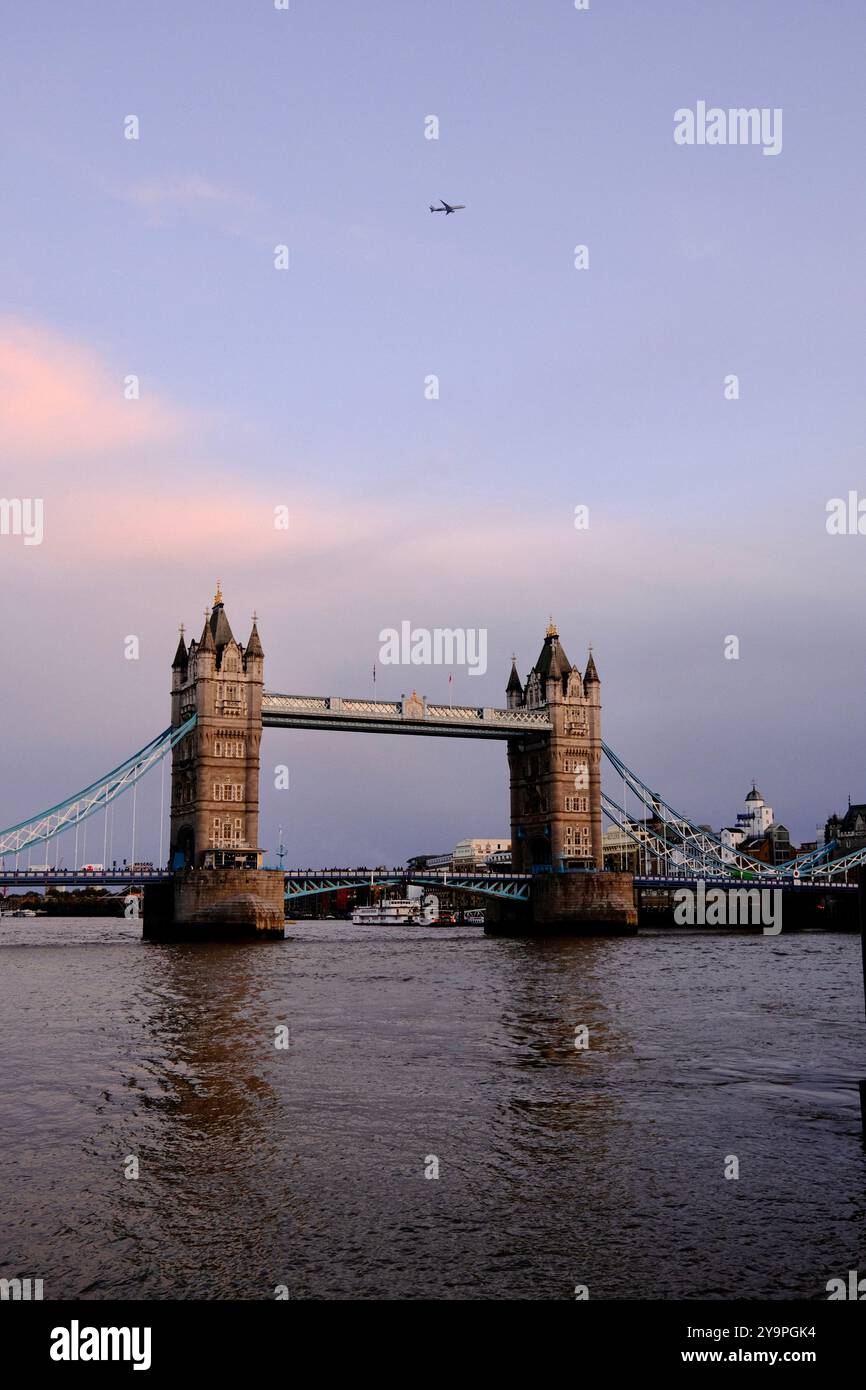 London bridge with pink sky and a plane flying overhead Stock Photo - Alamy
