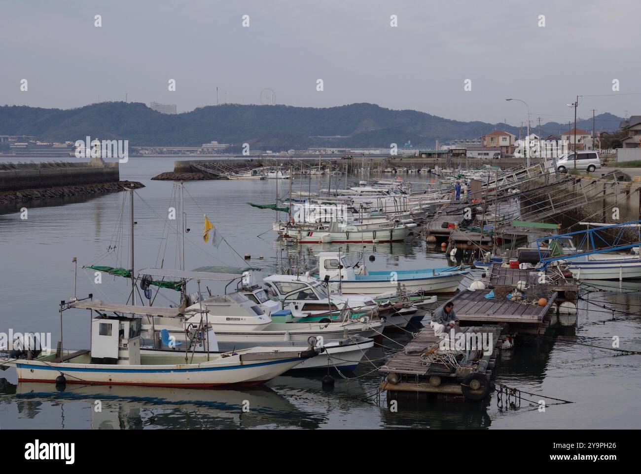 View of fishng boats moored in a small harbour near Okayama in Japan ...