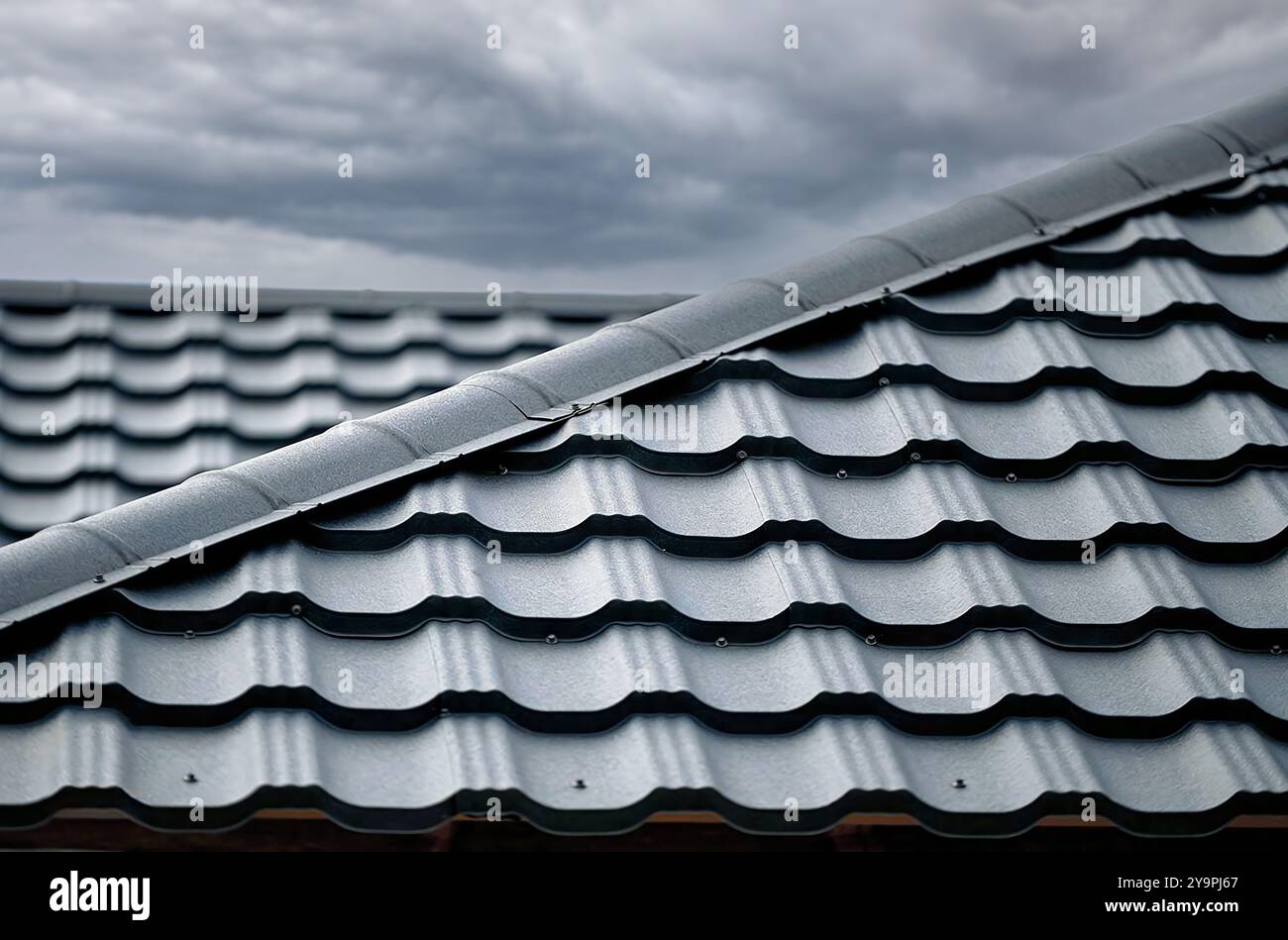 Close-up house roof with steel roofing sheet. Gray modular tile effect ...