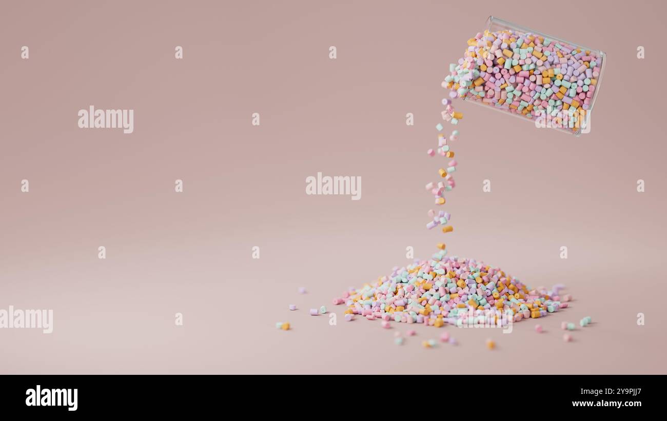 Colorful pastel plastic polypropylene granules pouring from the glass ...