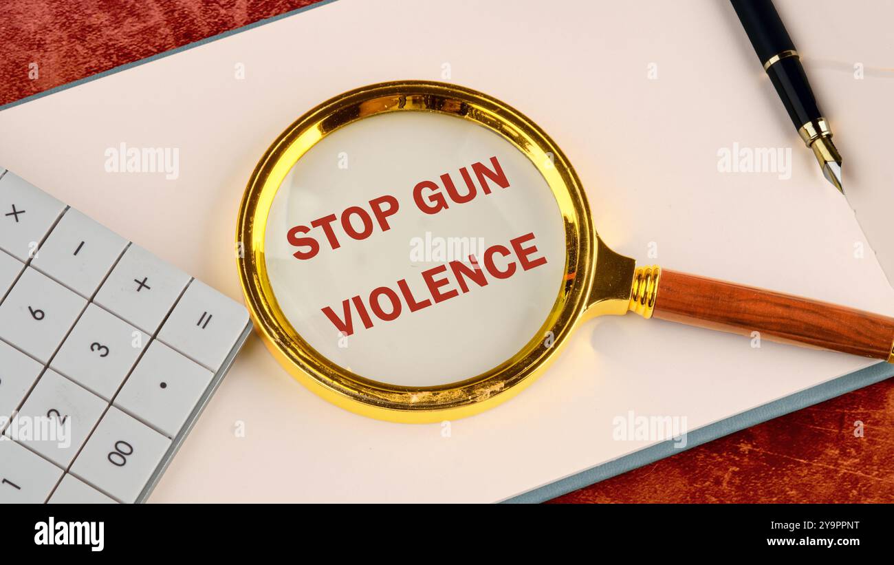 STOP GUN VIOLENCE text written on a blank page of a business notebook ...