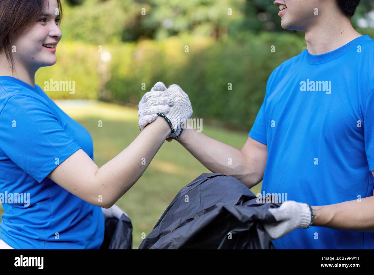 Young Volunteers Collaborating in Outdoor Cleanup Effort with ...