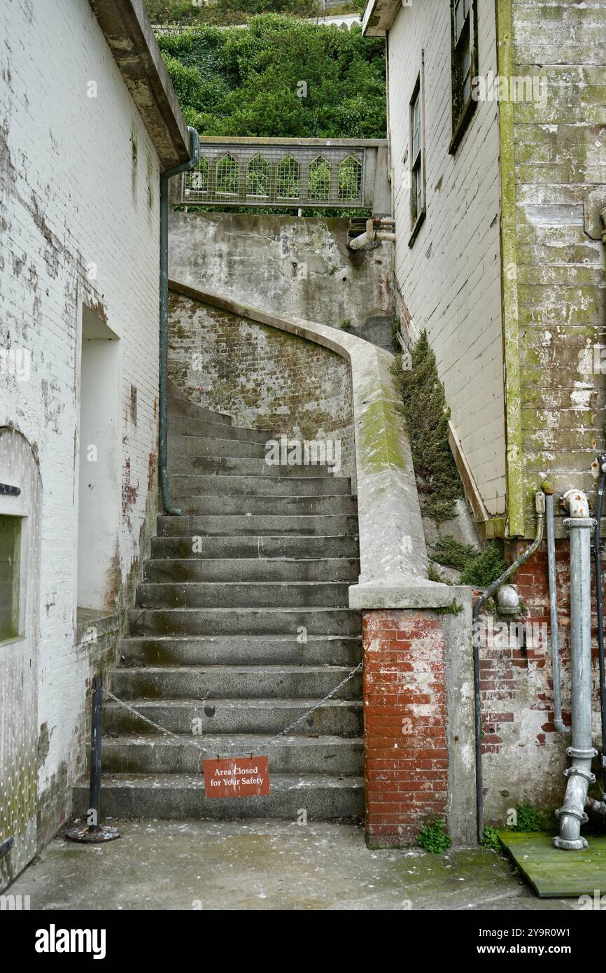 Concrete stairs leading upwards between buildings on Alcatraz Island ...