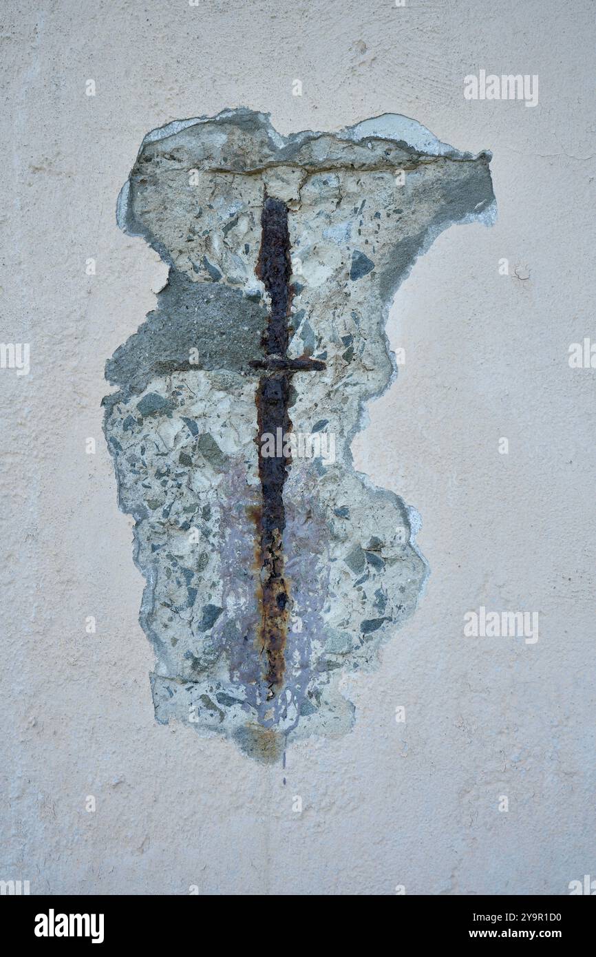 Metal rebar concrete reinforcement showing through broken wall on ...