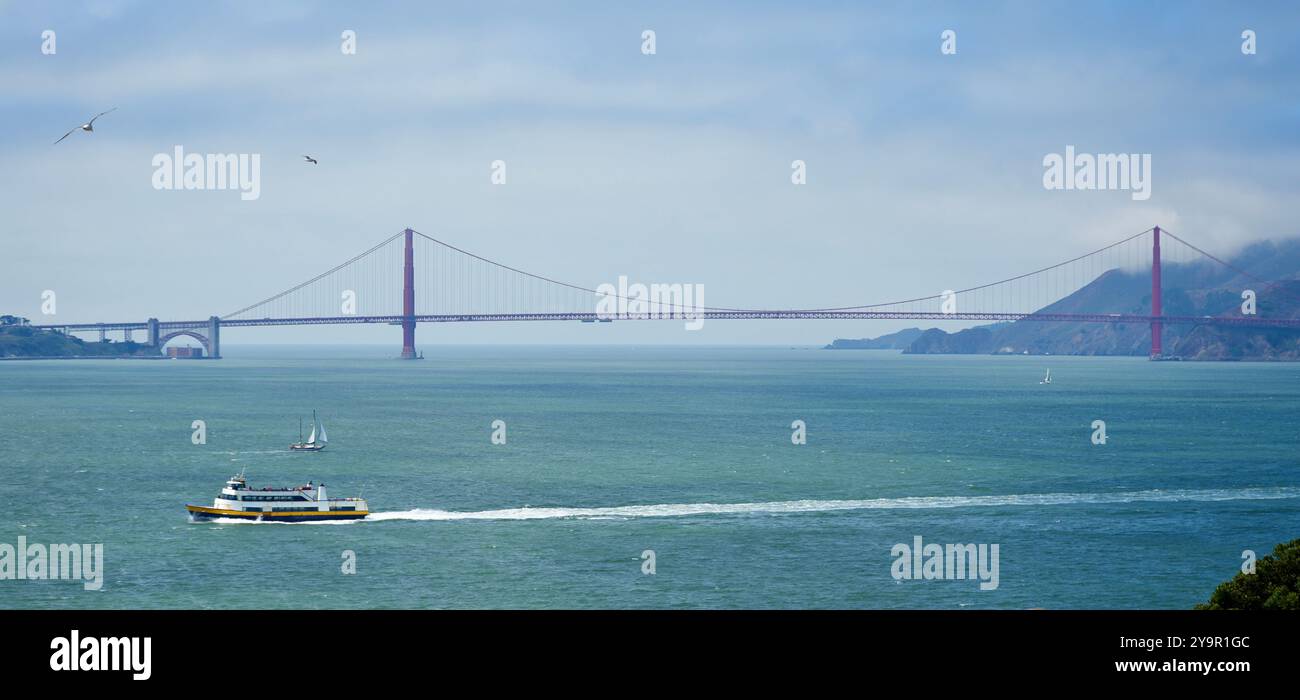 Passenger ferry passing The Golden Gate Bridge, viewed from Alcatraz ...