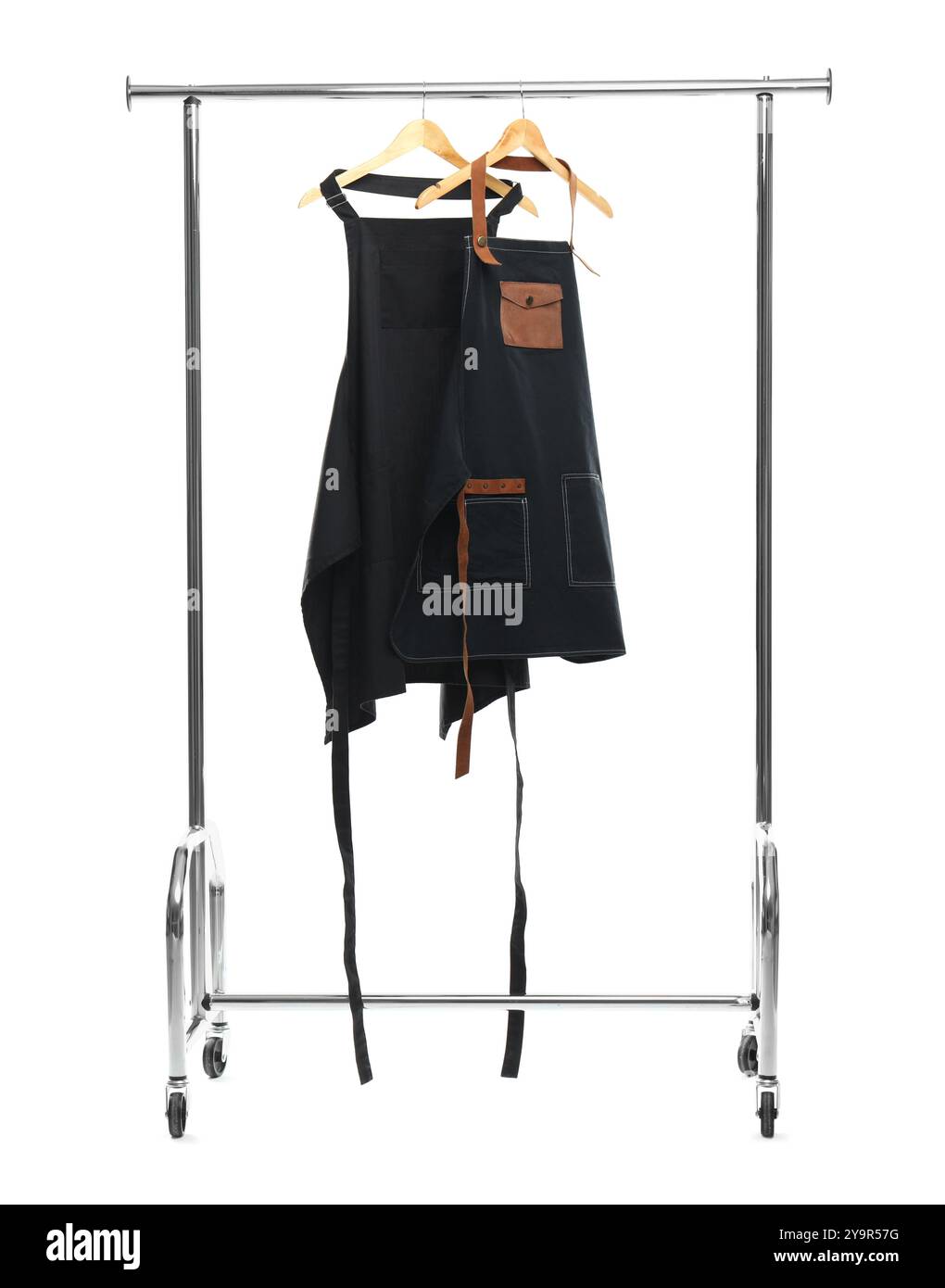 Two aprons on clothing rack isolated on white Stock Photo - Alamy