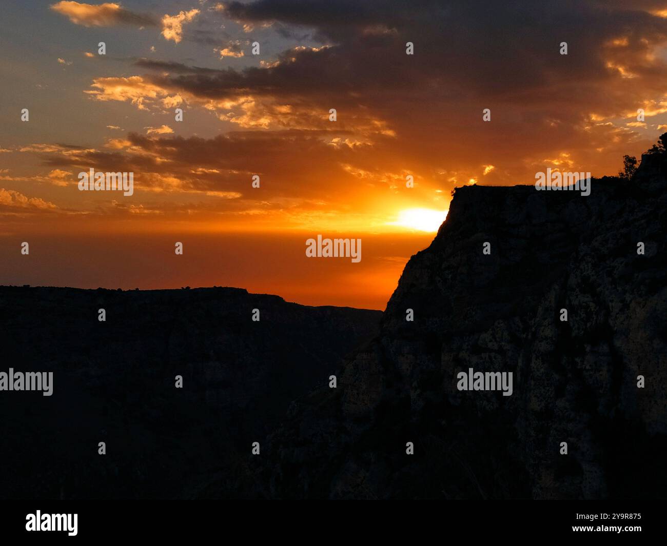 Dramatic Sunset on Mountains with Dark Silhouettes and Fiery Sky ...