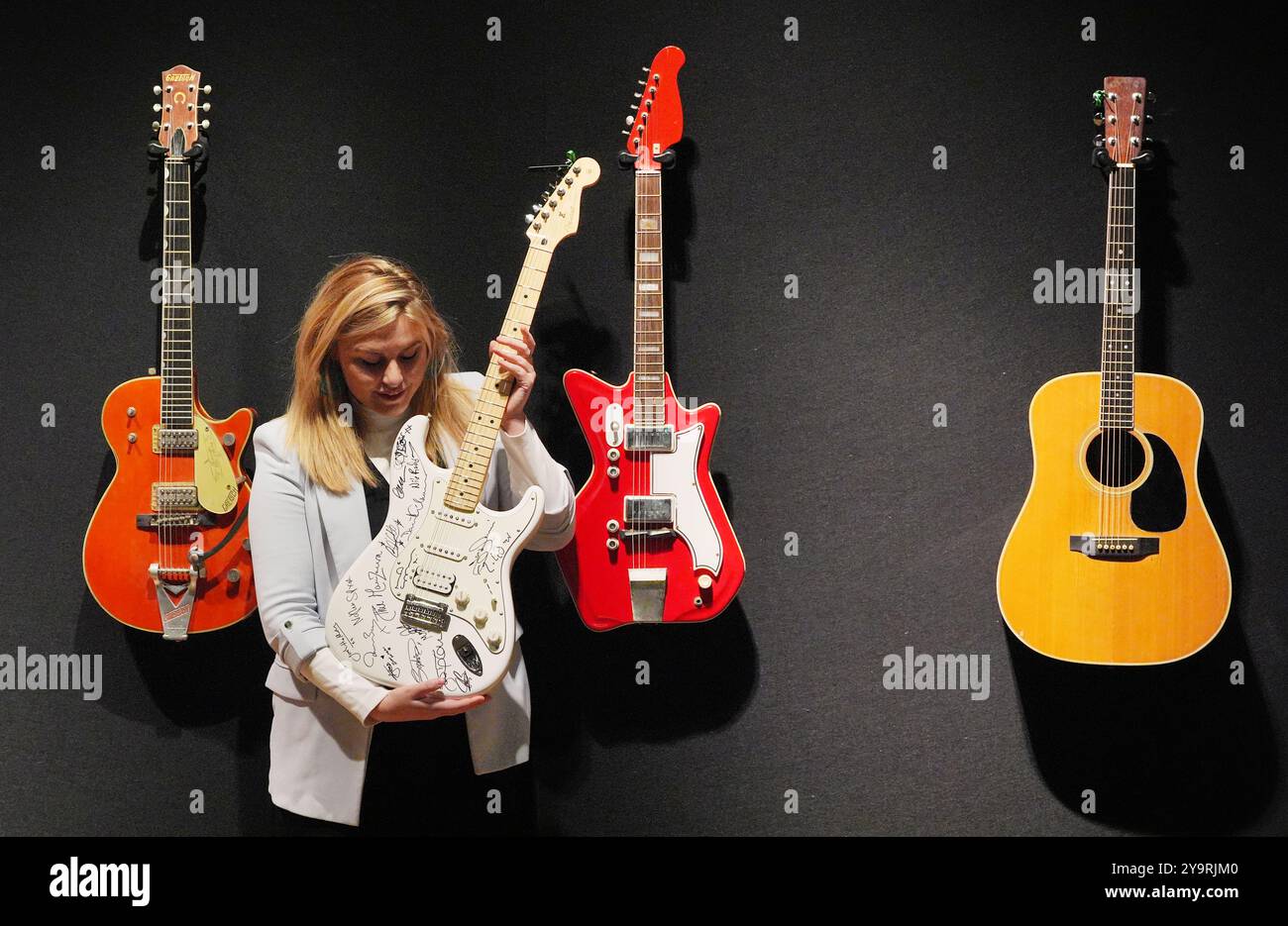 A member of Bonham's staff holds a Fender Stratocaster Player HSS ...