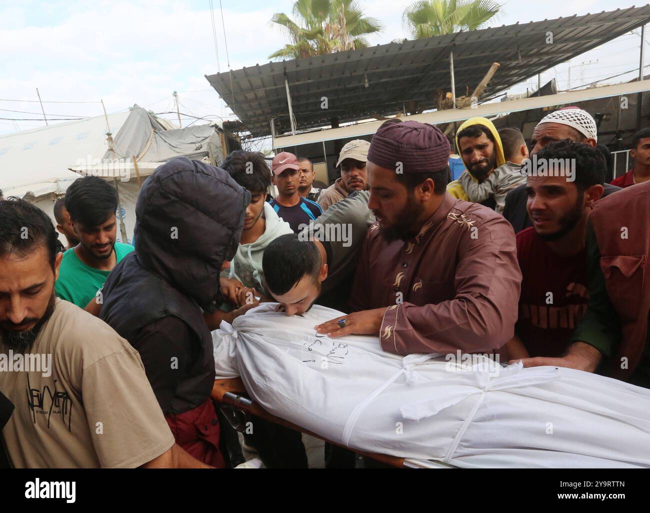 Palestinians mourn for the loss of loved ones after an Israeli army s attack in Deir Al Balah ...