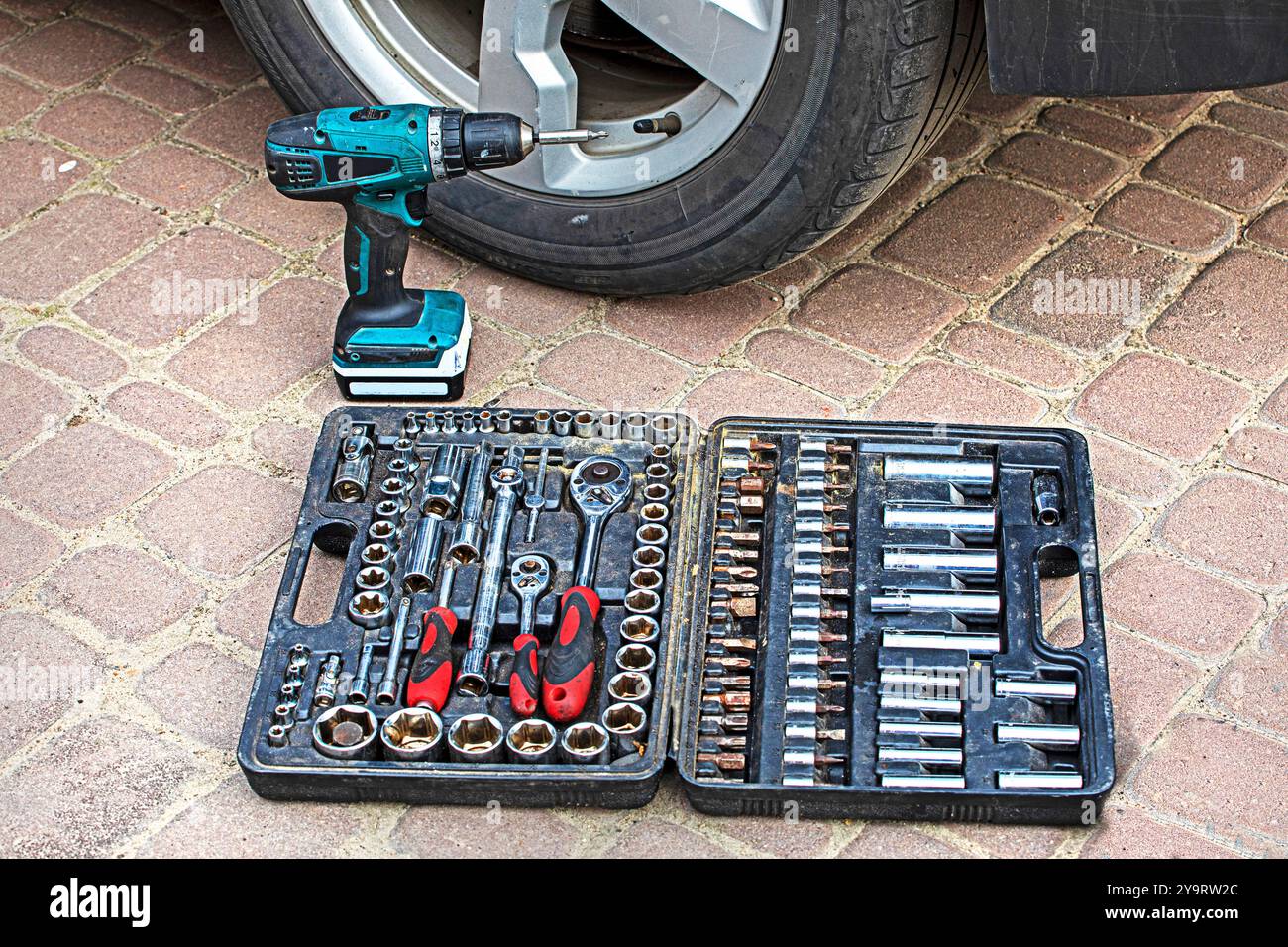 set of tools laid out for fastening to street tiles Stock Photo - Alamy