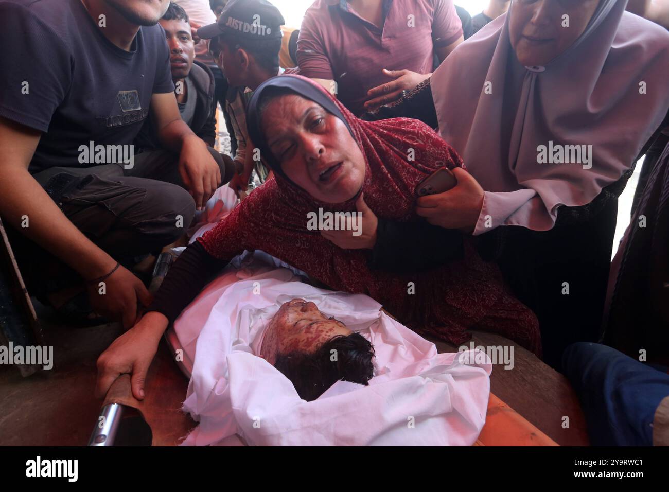 Palestinians mourn for the loss of loved ones after an Israeli army s attack in Deir Al Balah ...