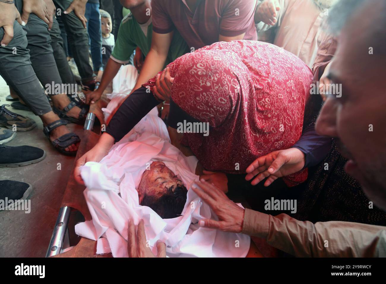 Palestinians mourn for the loss of loved ones after an Israeli army s attack in Deir Al Balah ...