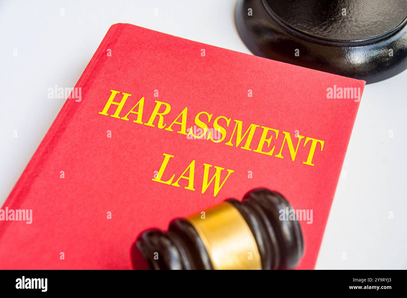 Side view of Harassment Law book with gavel on white background. Zero ...