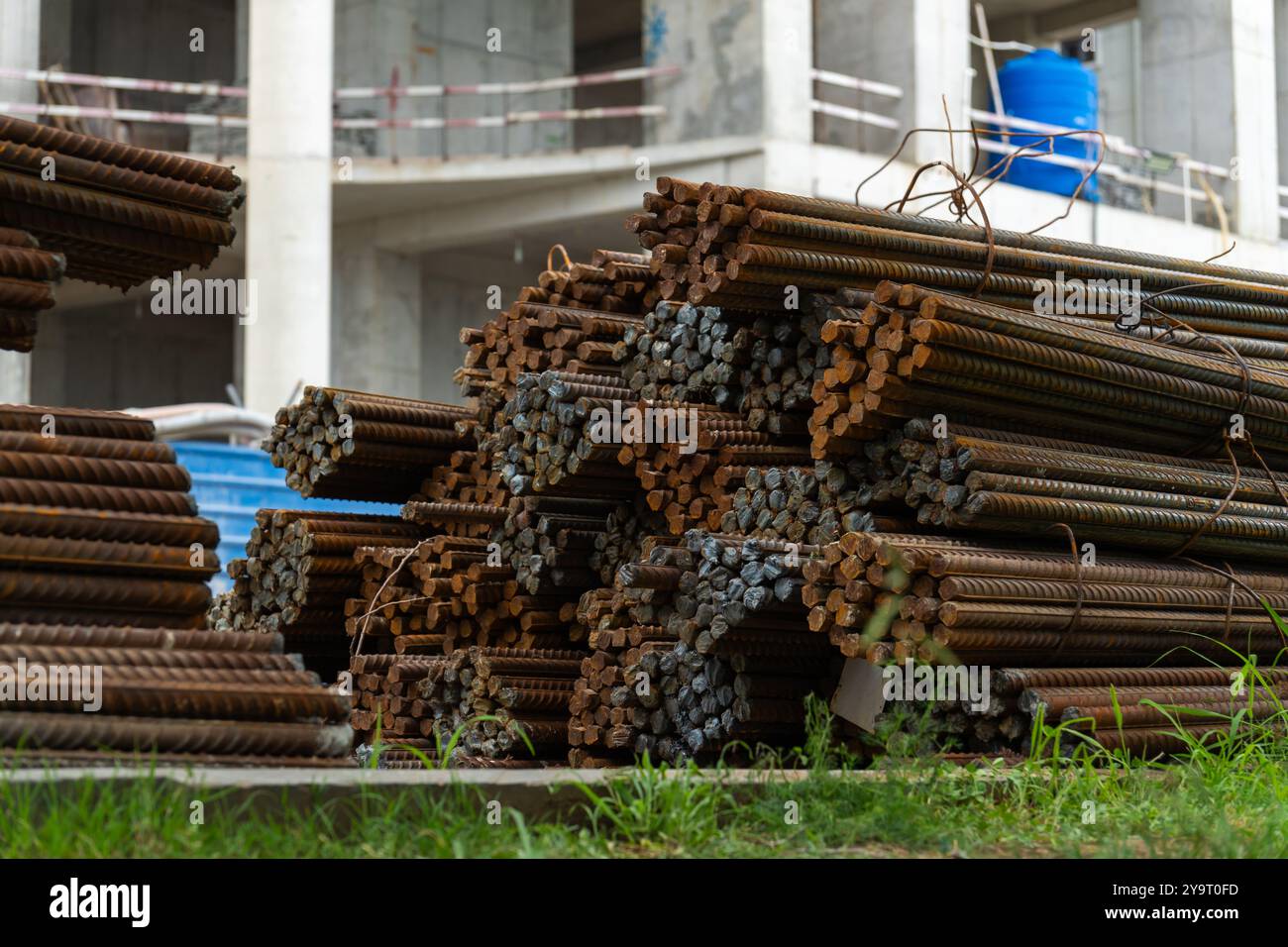Stack of rusty metal reinforcement bars lying outdoors waiting for ...