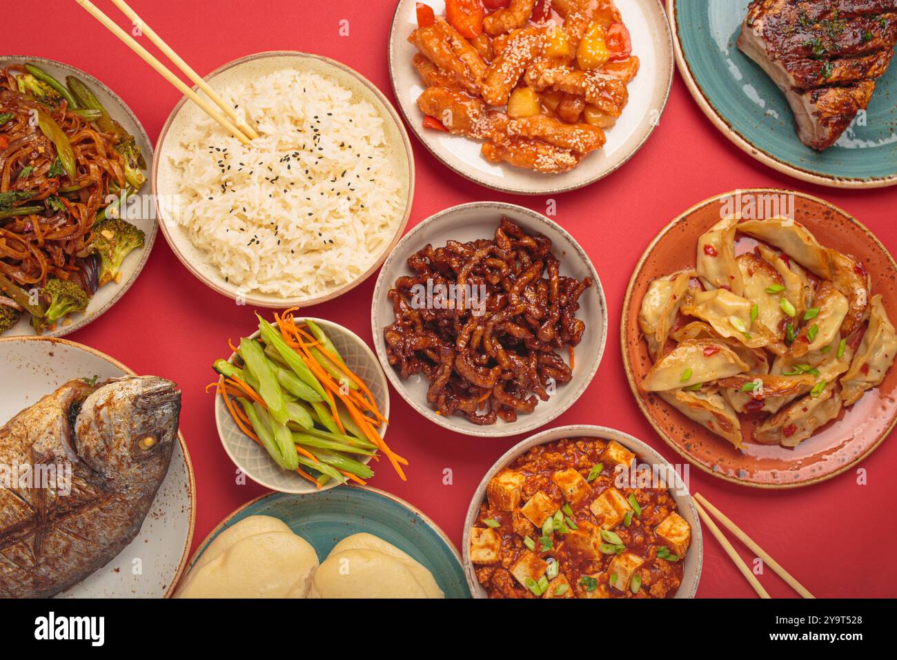 Assorted traditional chinese dishes top view on red background: kung ...