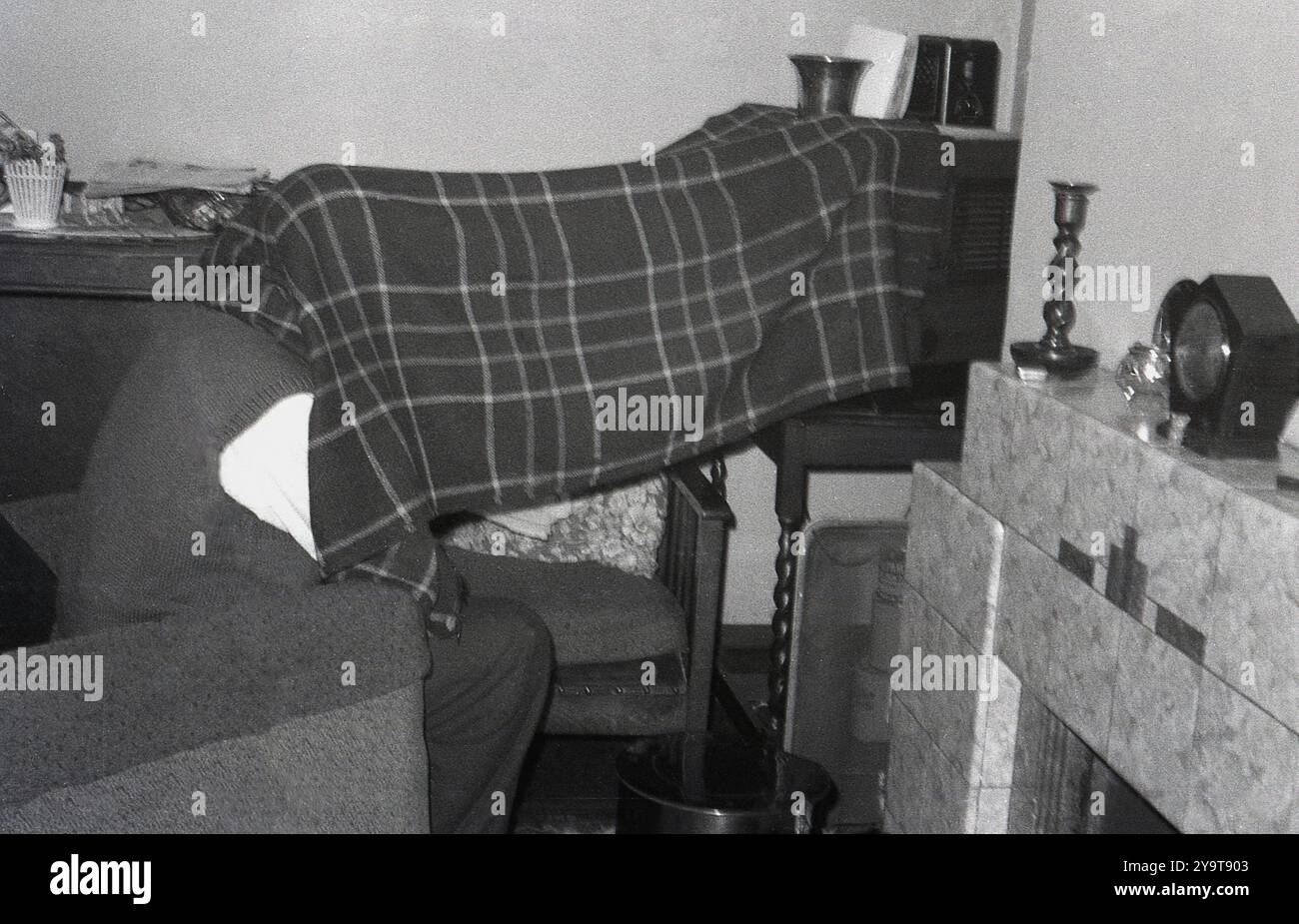 1960s, historical, inside a front room, a man sitting in an armchair ...