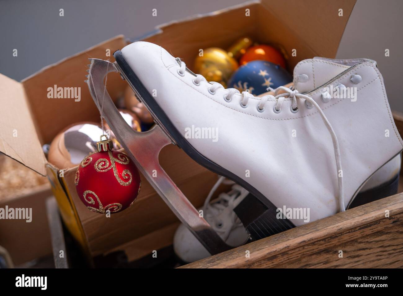 rustic storage solution white ice skates and cardboard box filled with ...