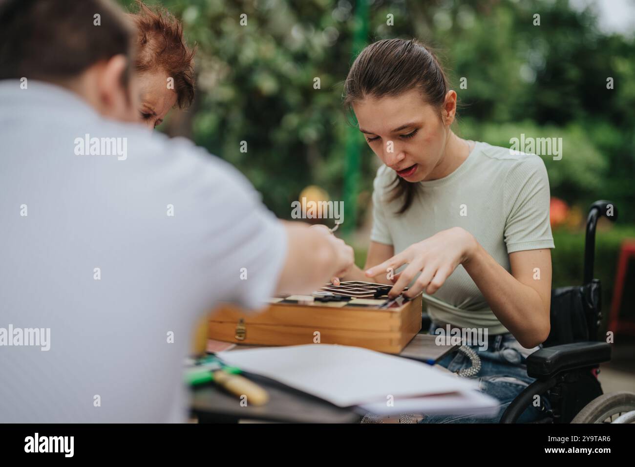 Inclusive group bonding while playing card games outdoors Stock Photo ...