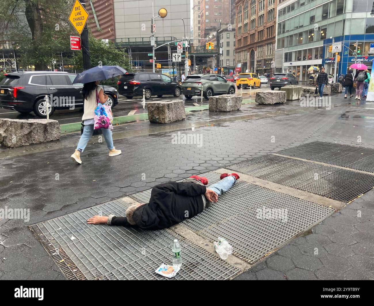 Homeless man asleep on a subway grating in Union Square in New York on ...
