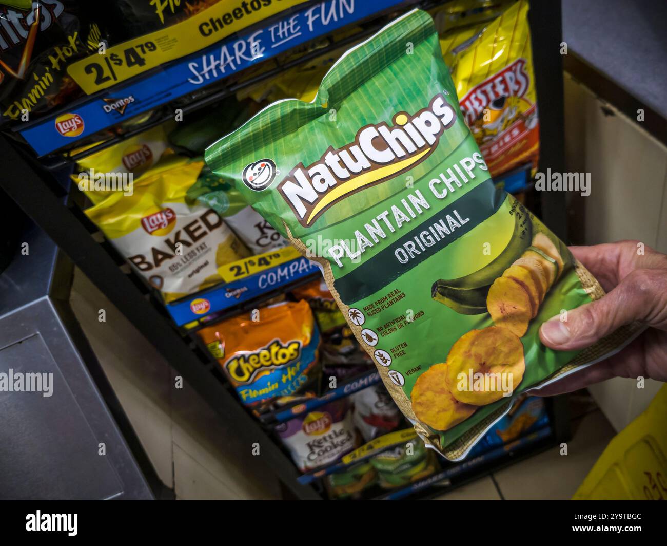 A customer chooses a package of NatuChips from a display of tasty ...