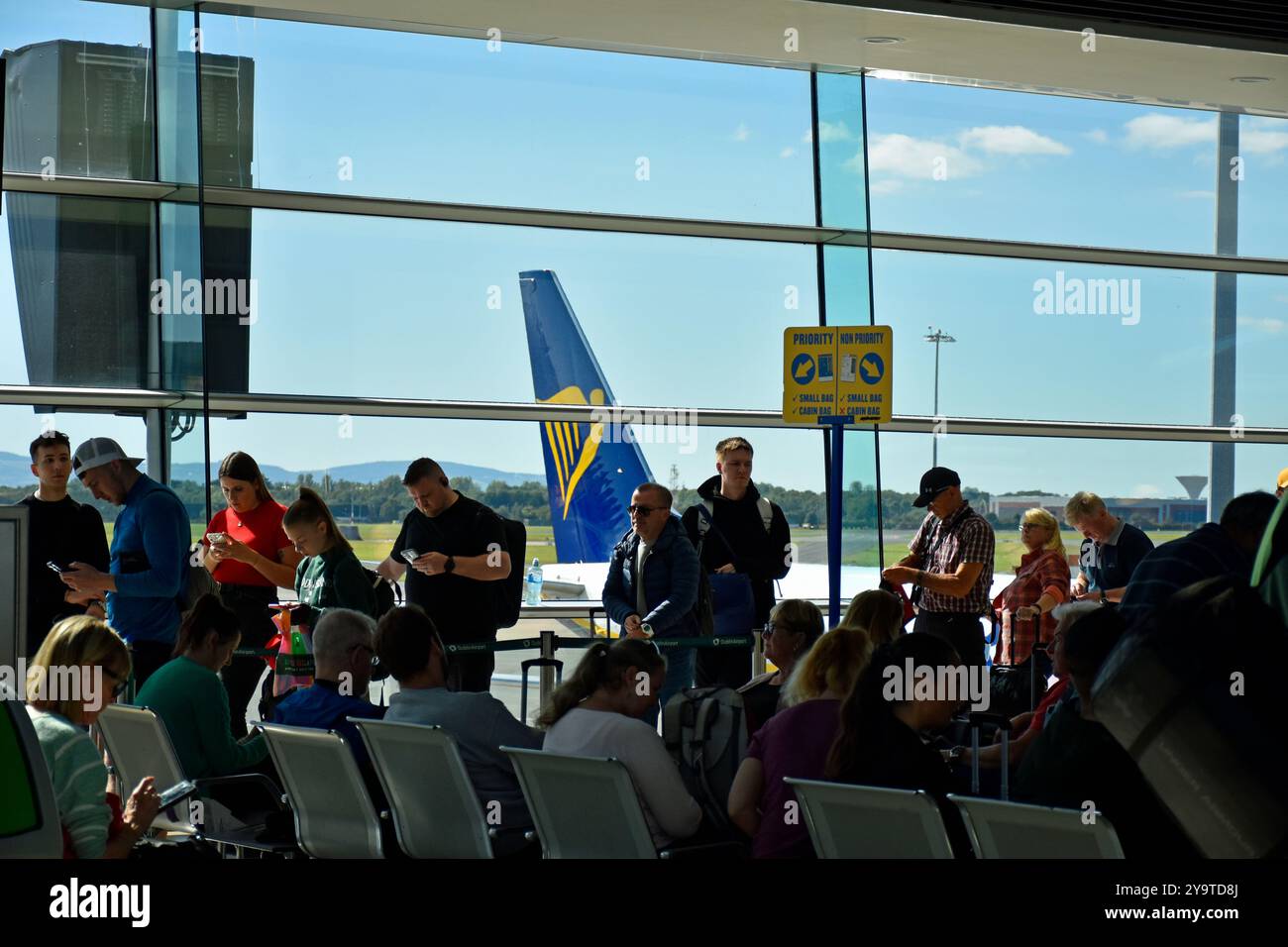 Dublin Airport Terminal One. Passengers queue to board a Ryanair flight ...